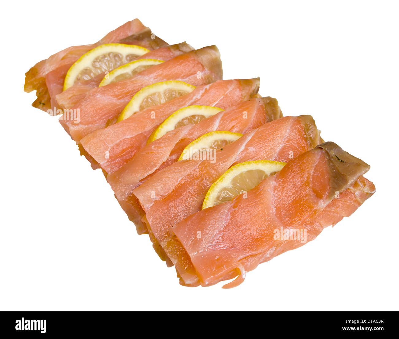 Smoked salmon sliced and arranged with lemon slices isolated against a ...