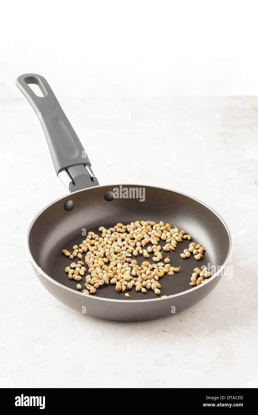 Coriander Seeds in small pan Stock Photo - Alamy