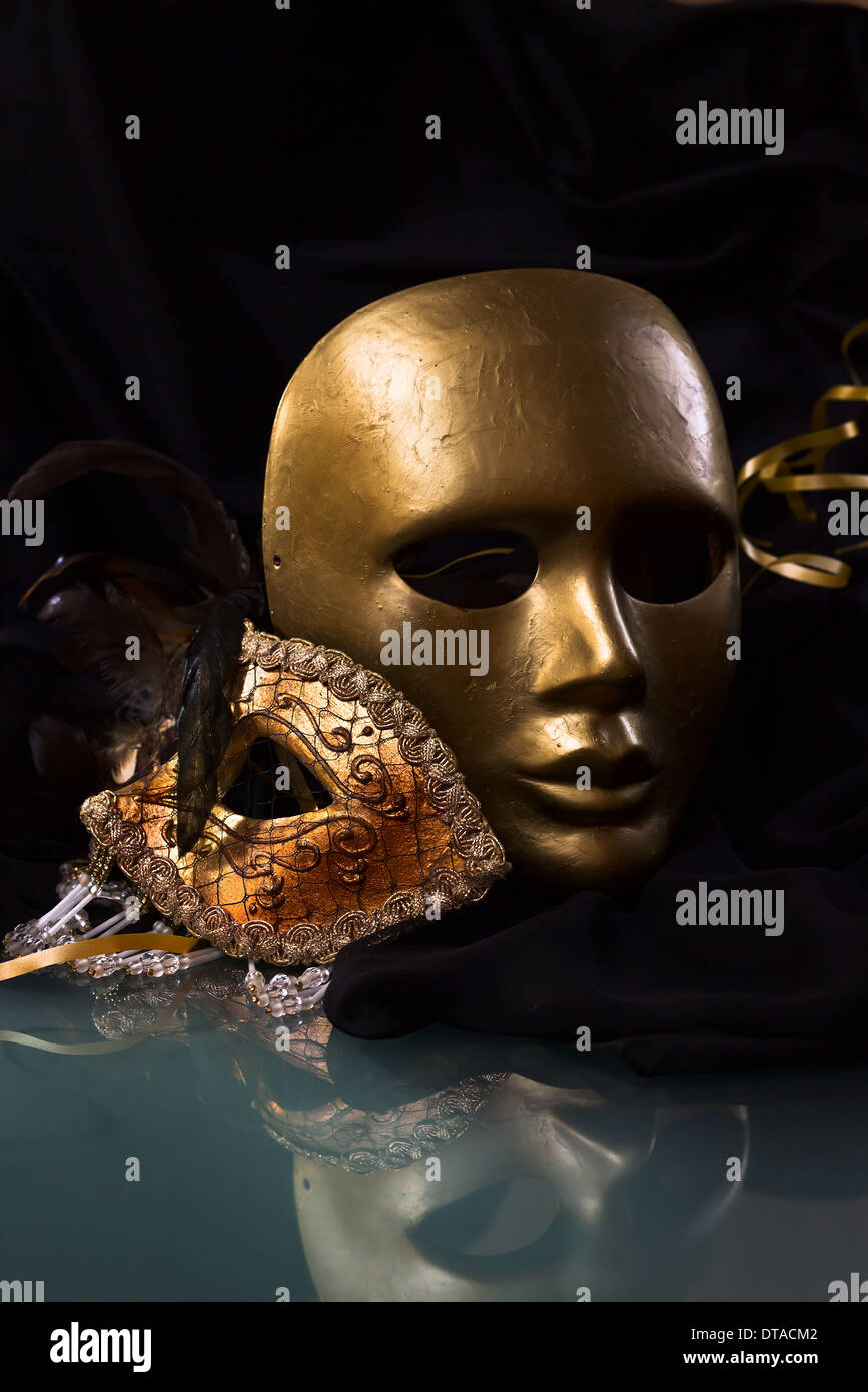 Old gold Venetian masks on a glass table Stock Photo - Alamy