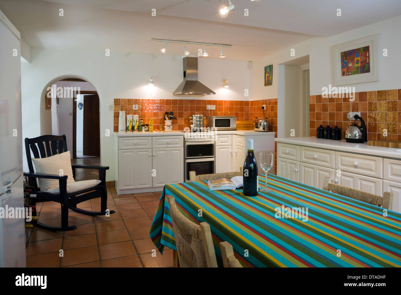 Contemporary kitchen with a dining table and chairs Stock Photo - Alamy