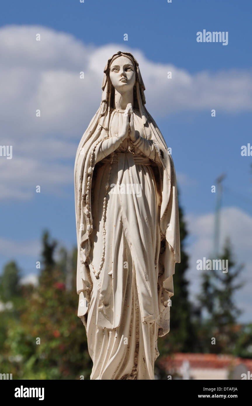 Virgin Mary hands joined in prayer marble funerary statue Stock Photo ...