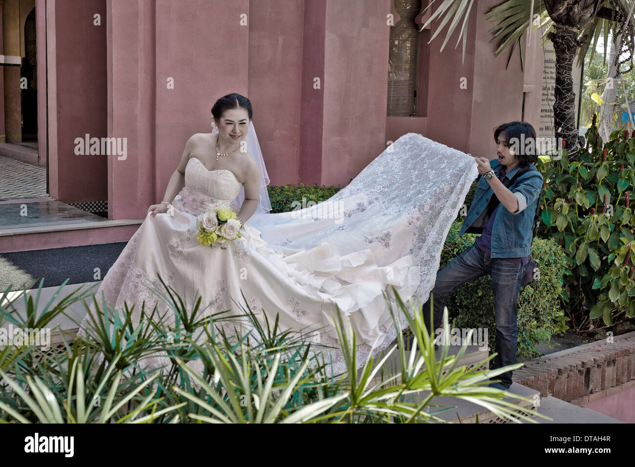 Wedding humor. Candid and amusing image of a photographers assistant ...