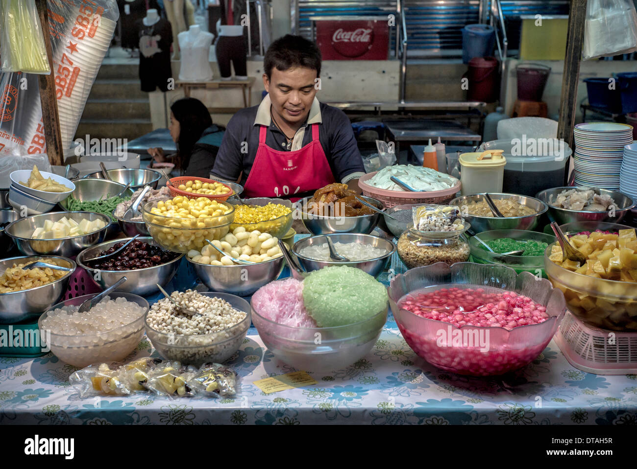 Thailand street market stall with vendor selling various fruit and ...