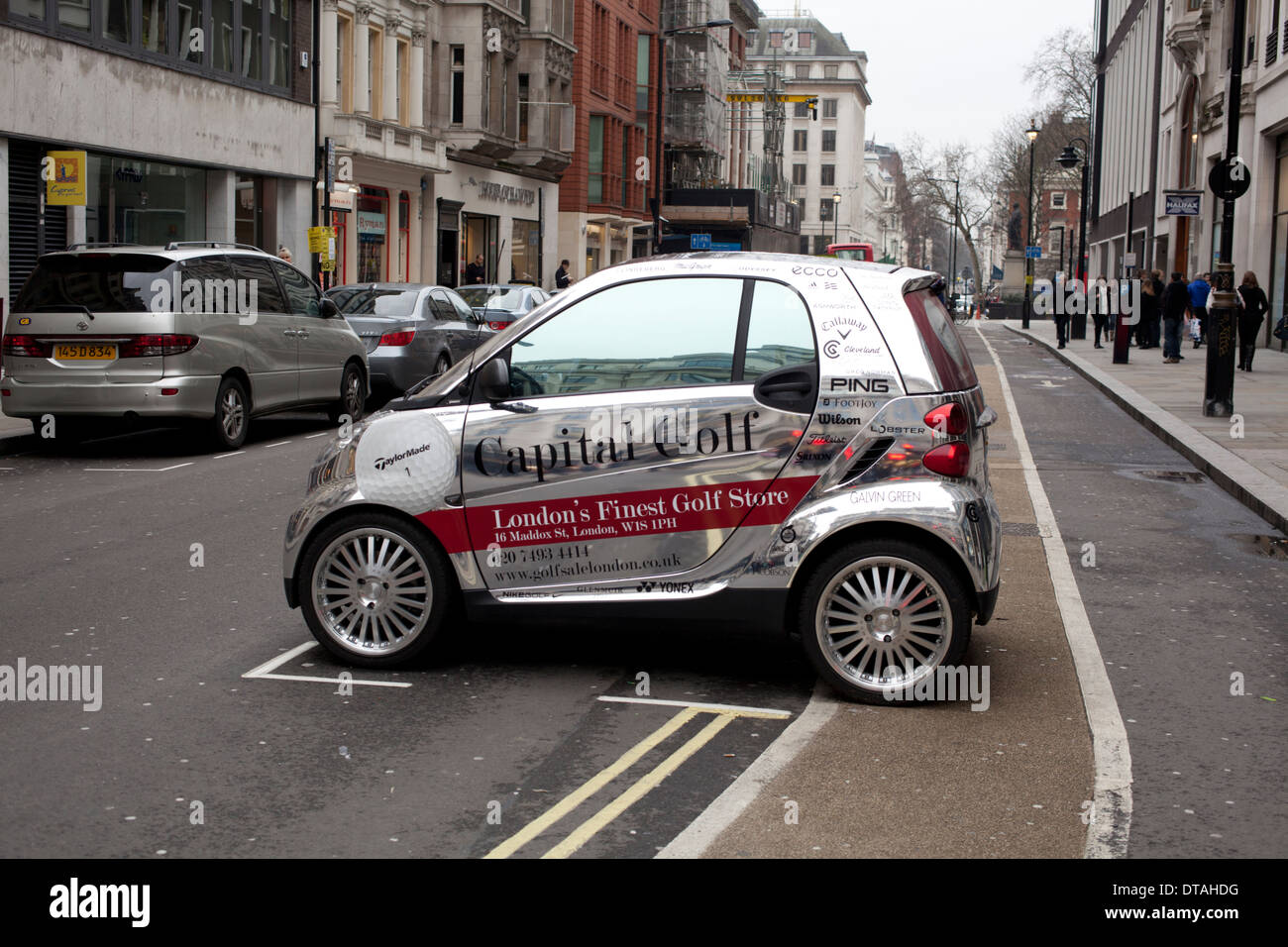 Smart car decorated with advertisements in the street in London Stock ...