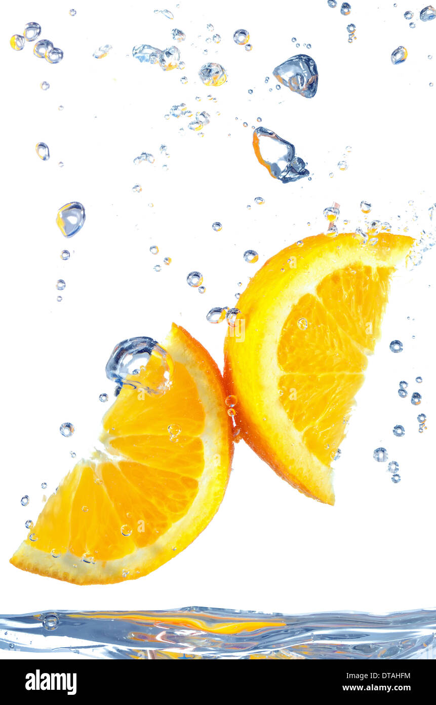 Orange slice splashing into water shoot in studio Stock Photo - Alamy