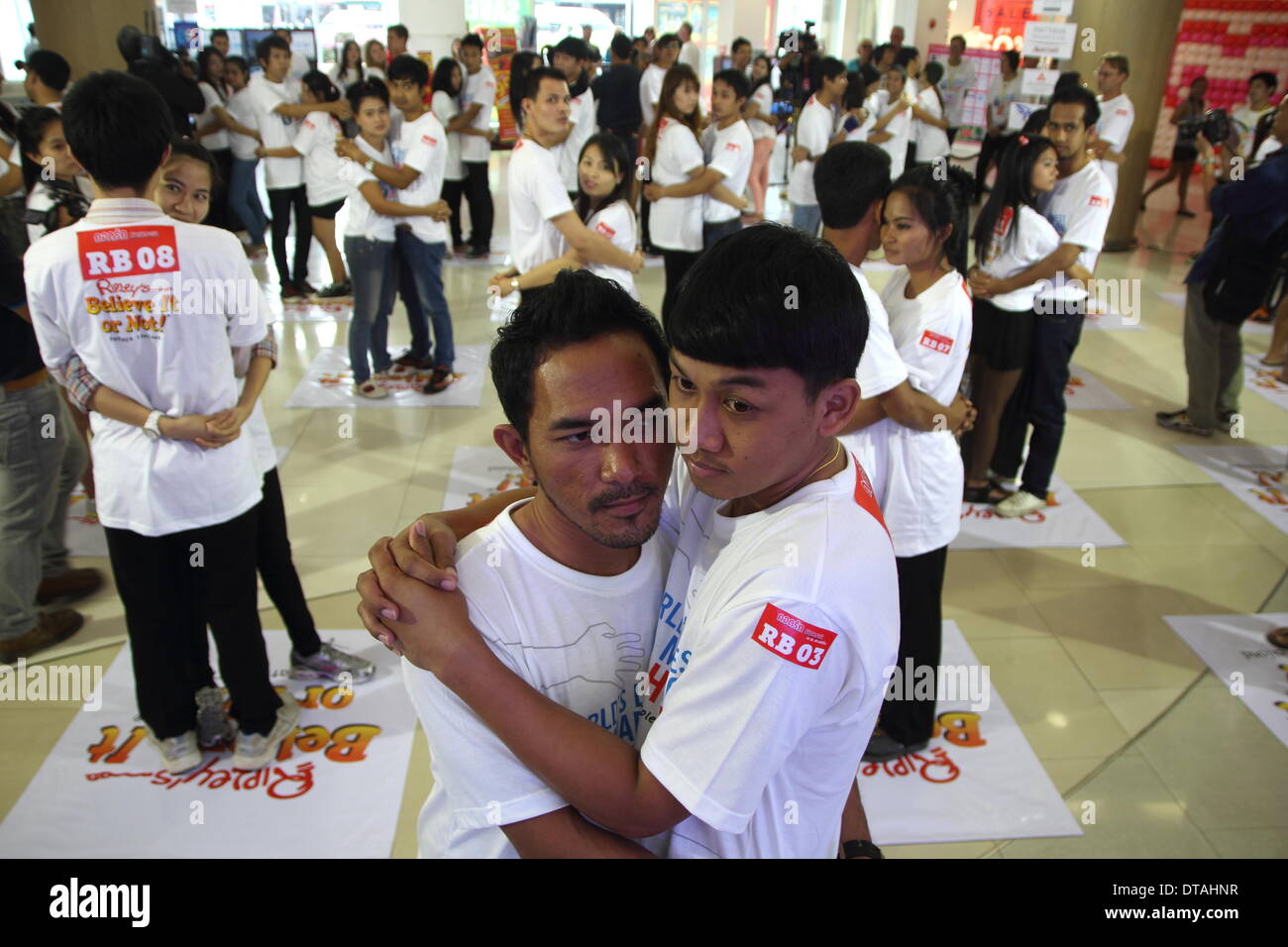 Pattaya, Thailand. 13 February 2014. Thai and foreign couples hug ...