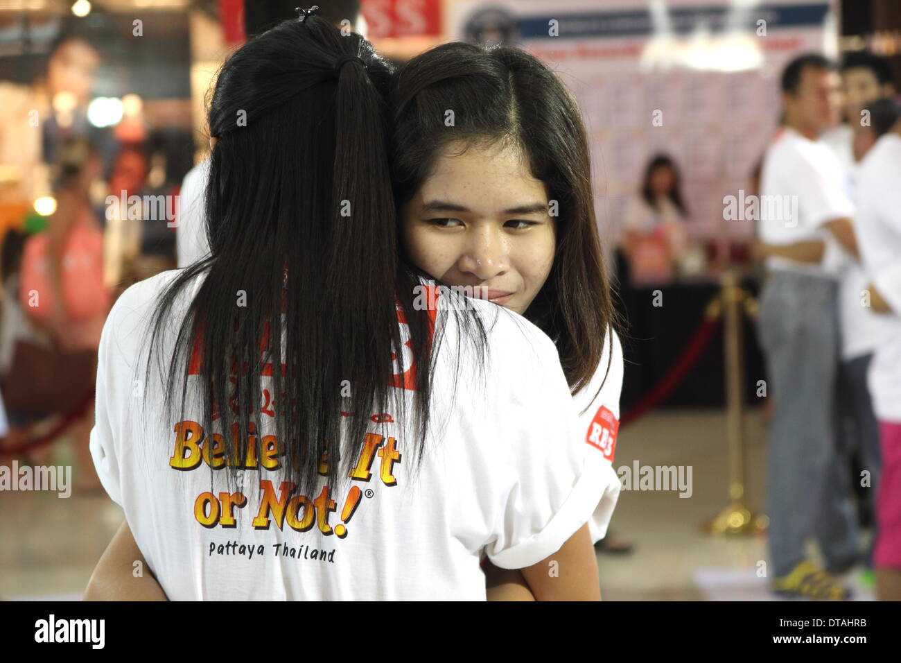 Pattaya, Thailand. 13 February 2014. Thai and foreign couples hug ...