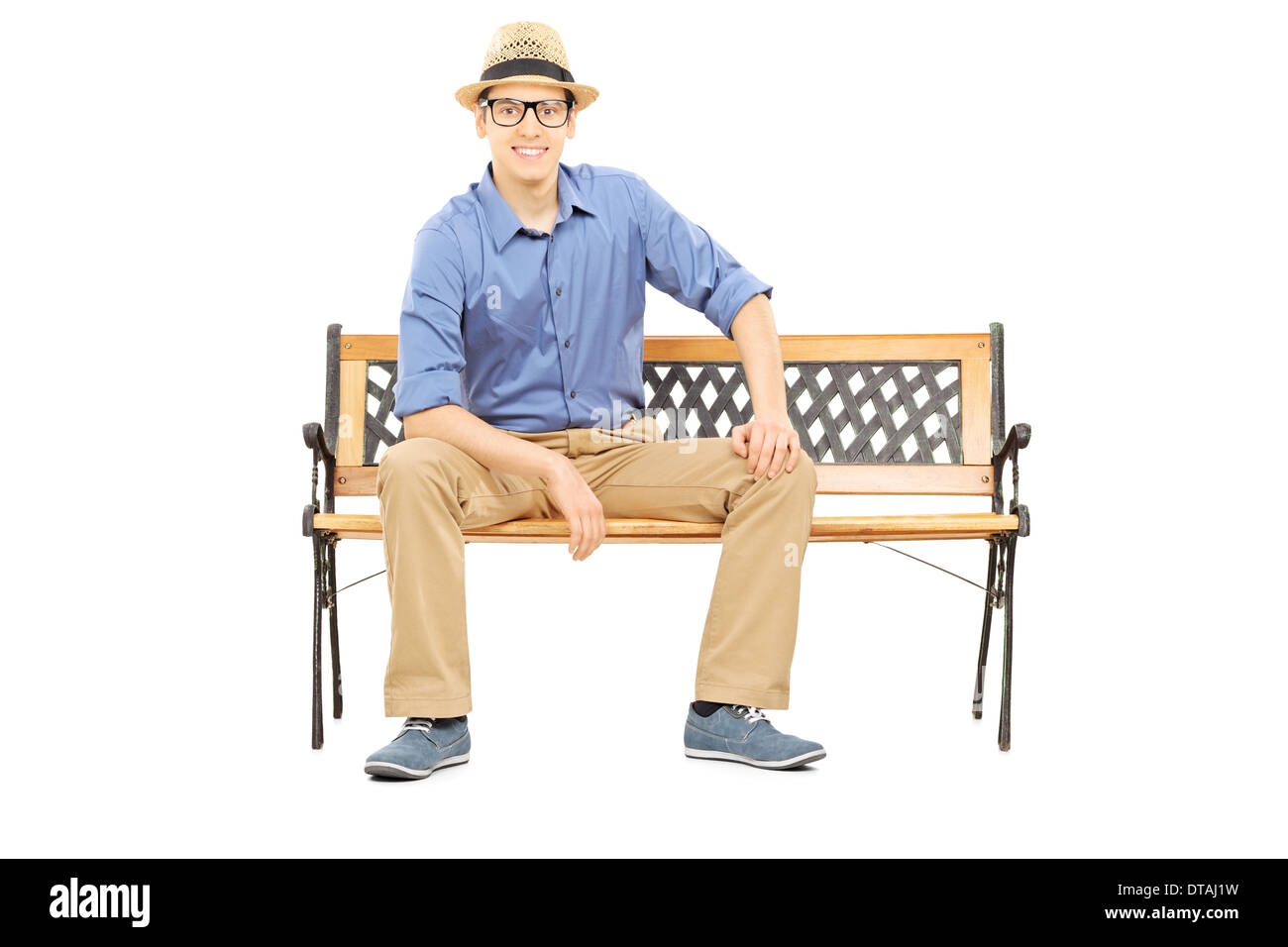 Casual young guy sitting on bench and looking at camera Stock Photo - Alamy