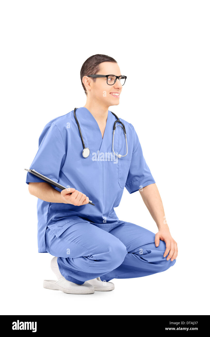 Male medical worker crouching and holding clipboard Stock Photo - Alamy