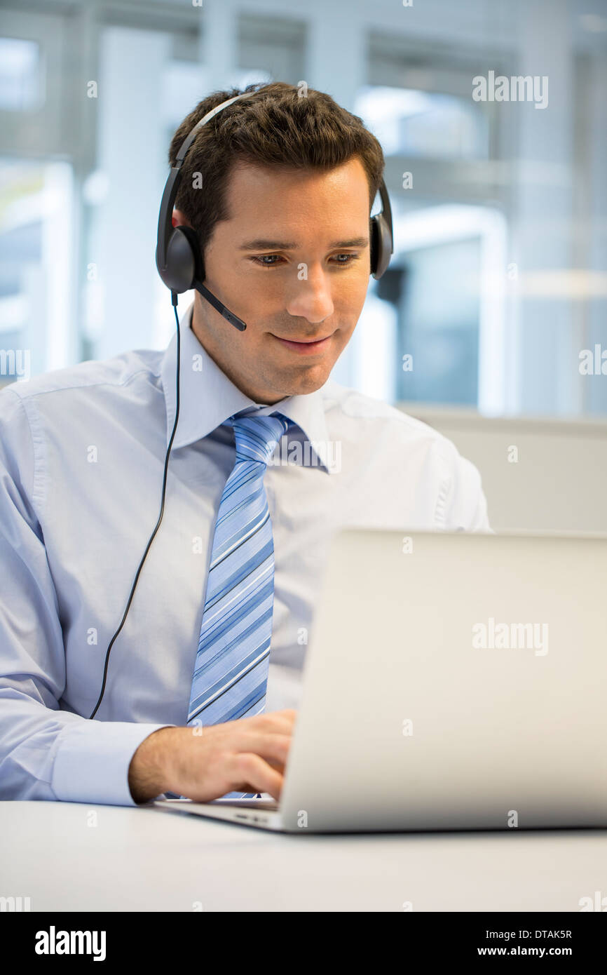 Businessman in office on phone with headset, hotline Stock Photo - Alamy