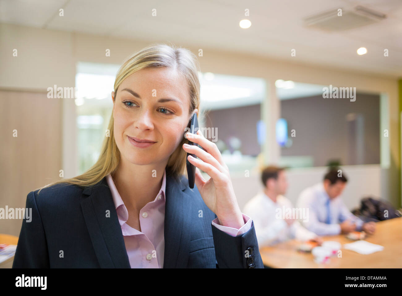 Businesswoman telephoning in her office Stock Photo - Alamy