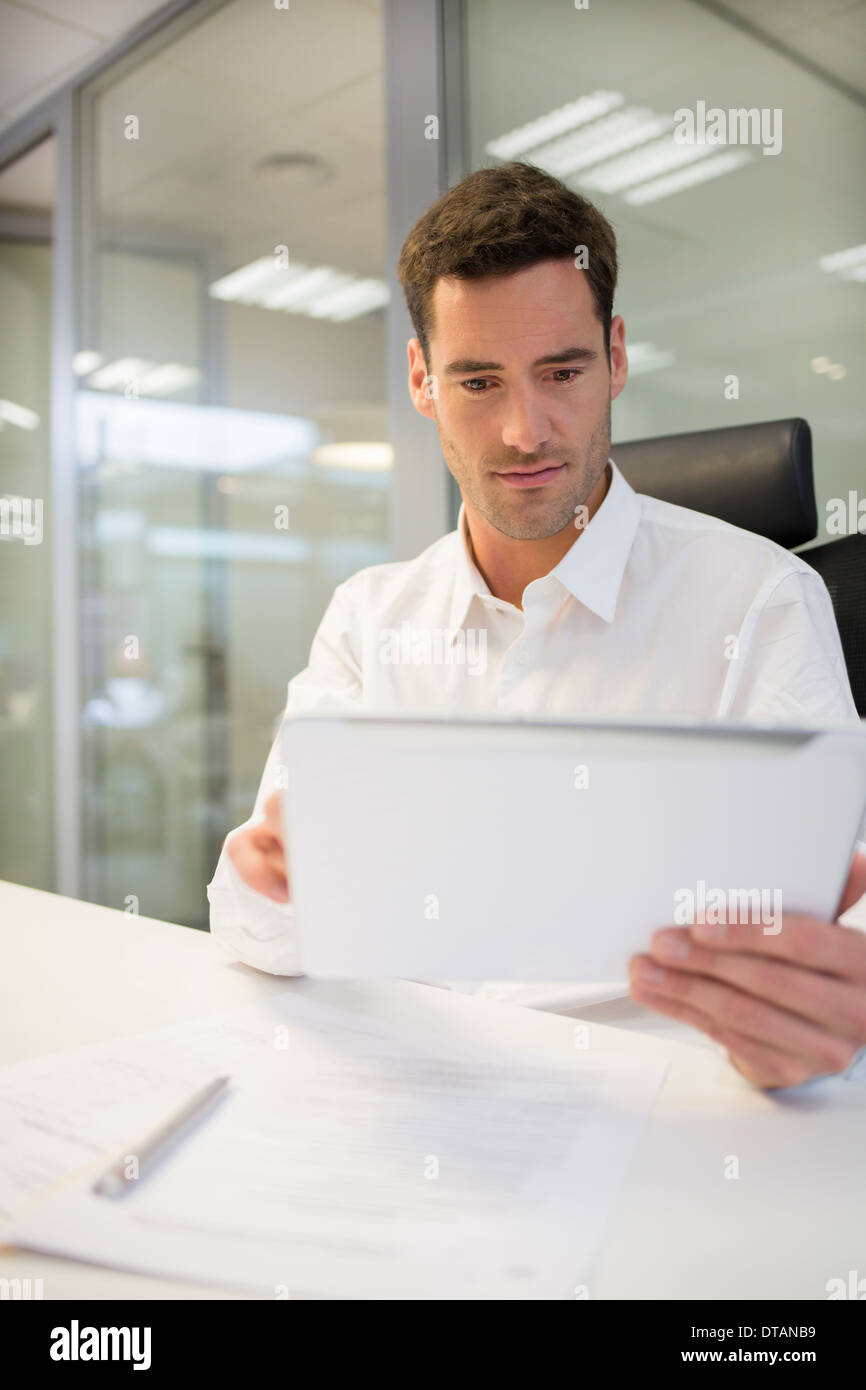 Businessman in office working on computer tablet Stock Photo - Alamy
