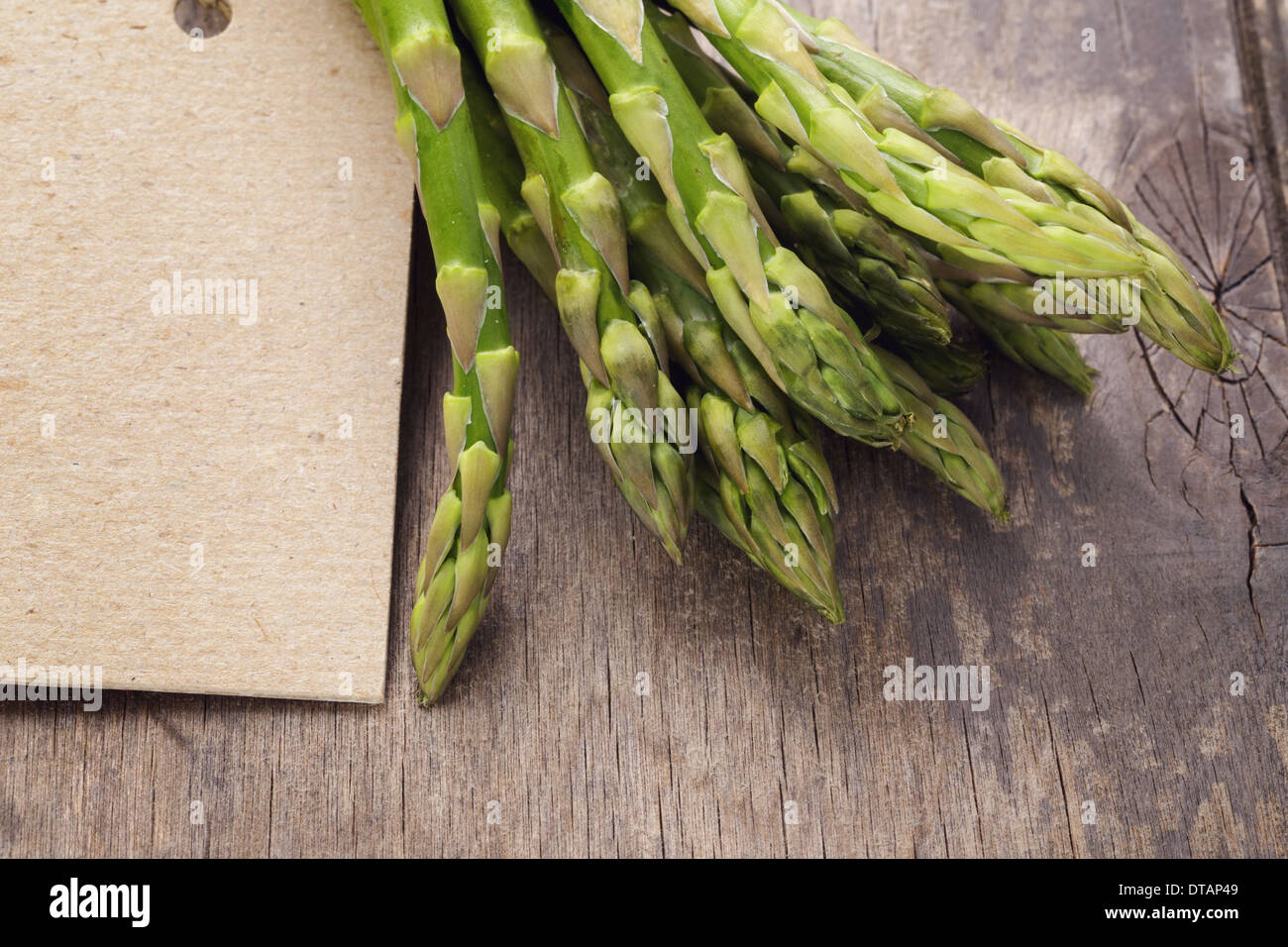 bunch of green asparagus close up with tag, rustic style for market ...