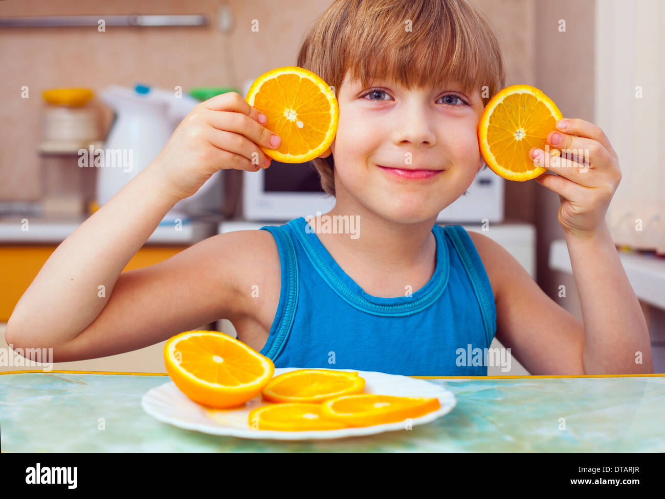 boy, breakfast, eats orange Stock Photo - Alamy