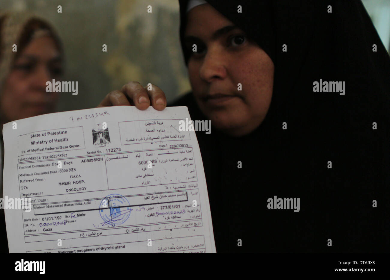Gaza City. 13th Feb, 2014. A Palestinian patient displays her document ...