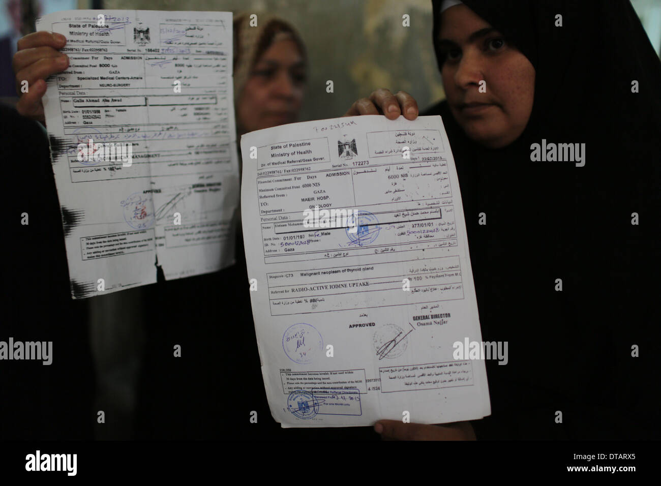 Gaza City. 13th Feb, 2014. A Palestinian patient displays her document ...