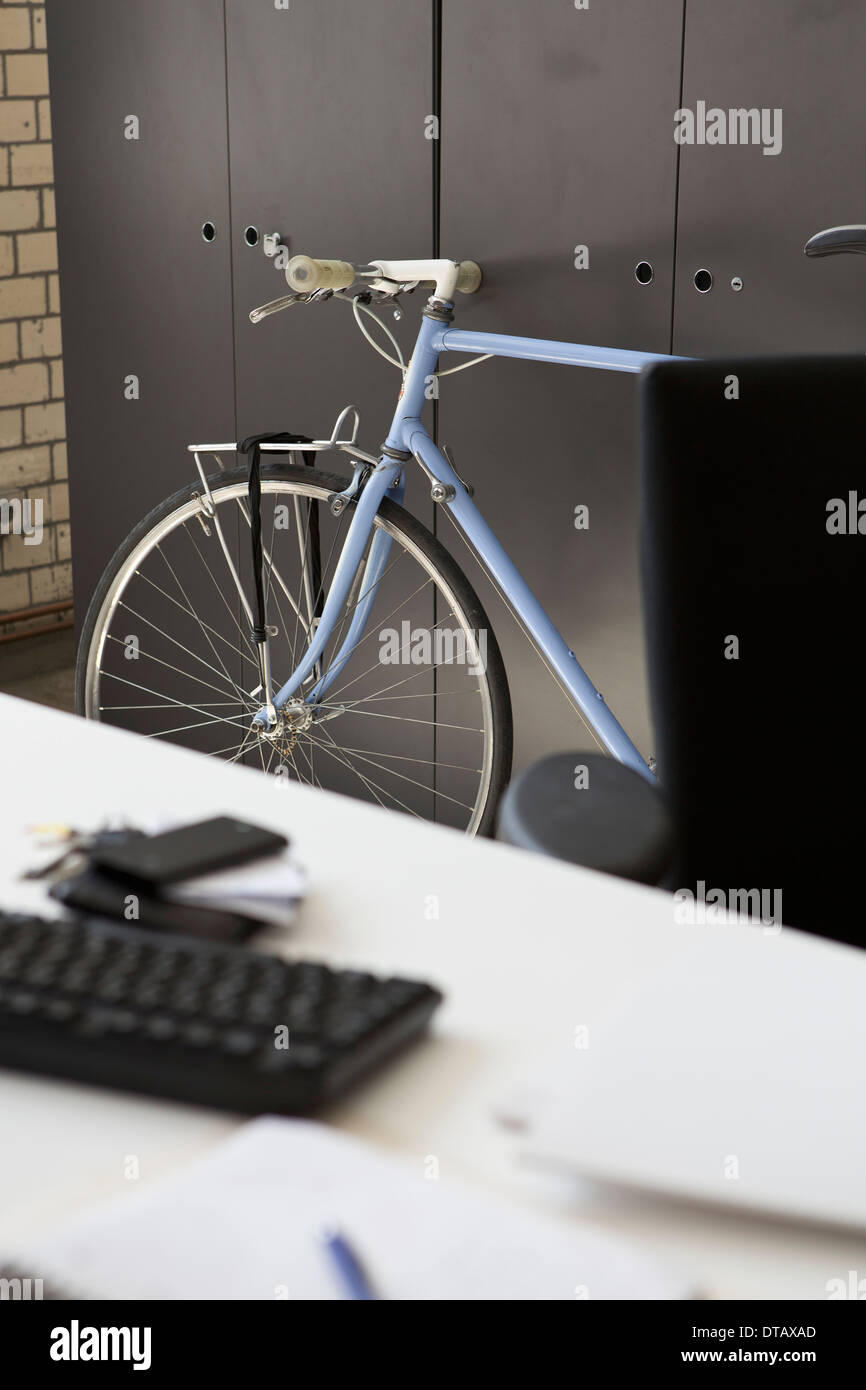 Bicycle at office table Stock Photo - Alamy