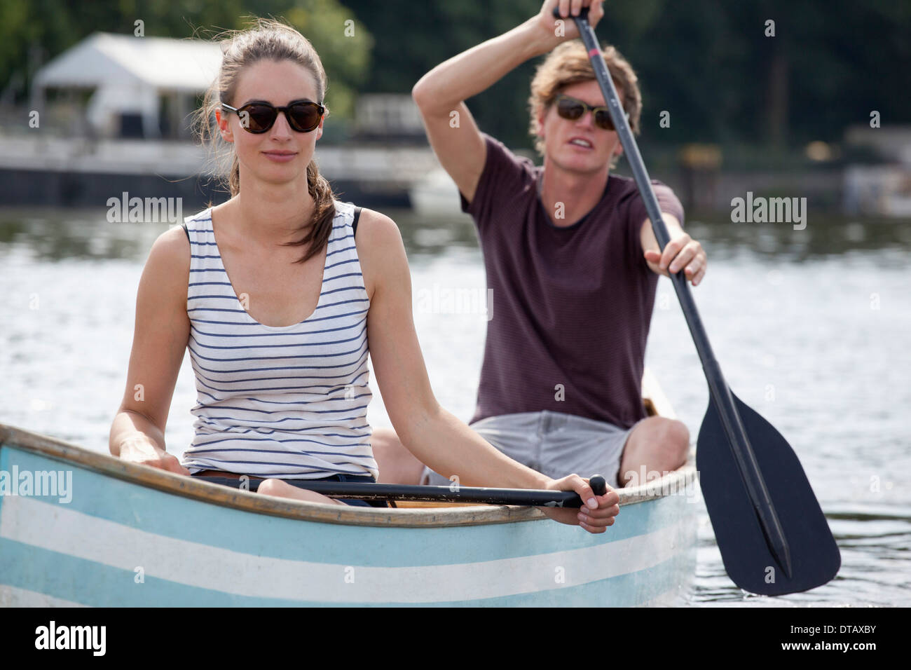 Young couple rowing canoe on lake Stock Photo - Alamy