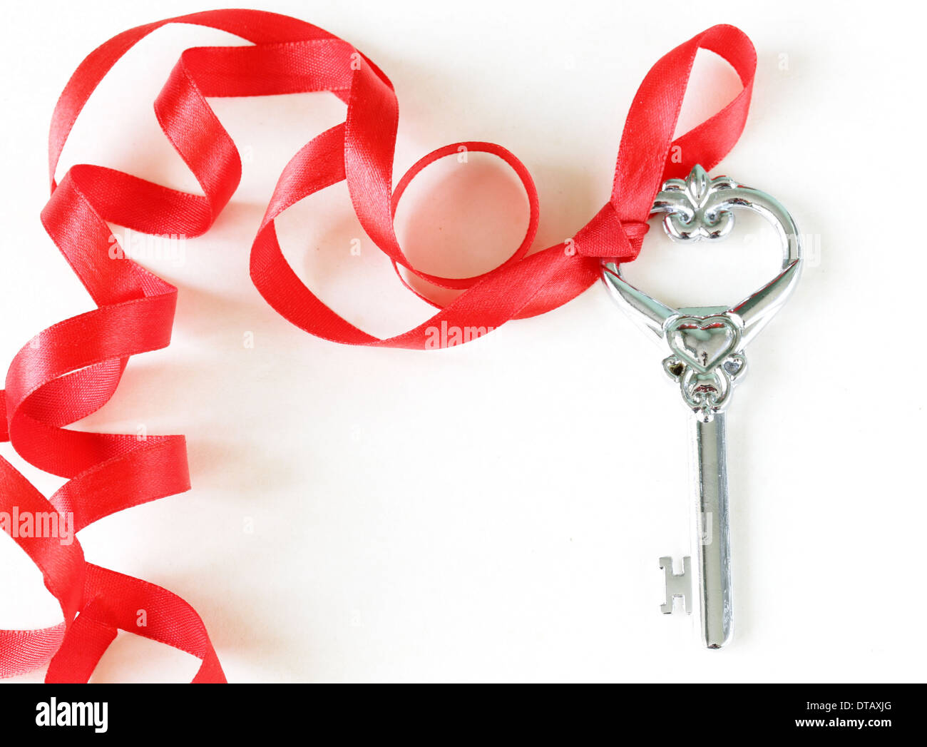 Vintage key with a festive beautiful red ribbon Stock Photo - Alamy