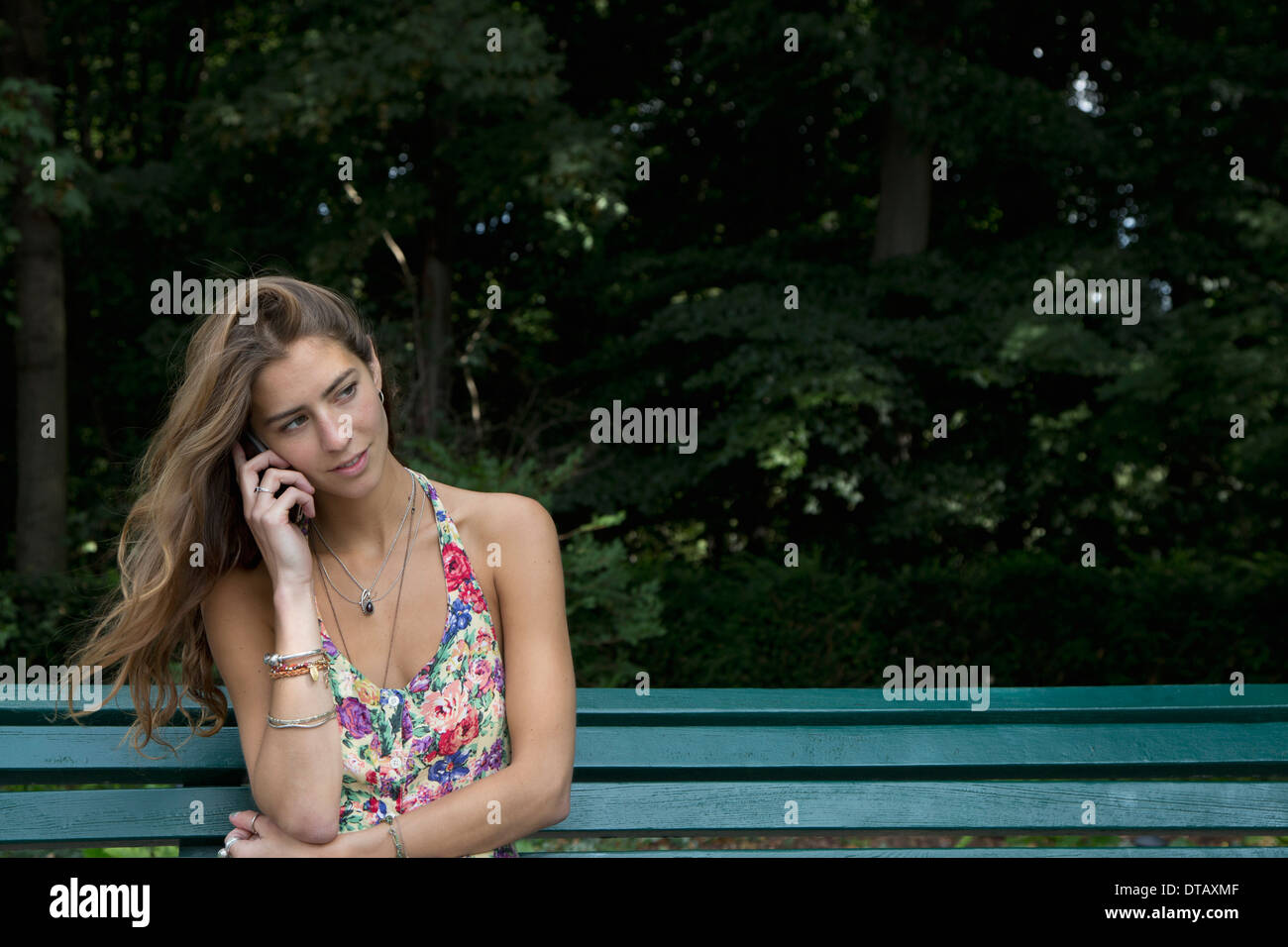 Woman sitting on park talking hi-res stock photography and images - Alamy