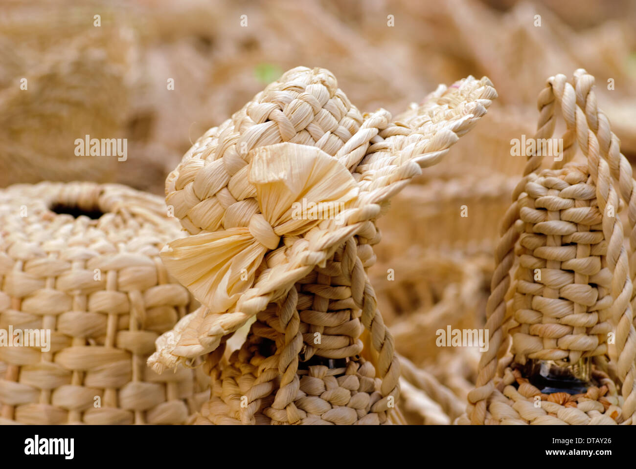 Basketry market on nature. Wicker cover for bottles Stock Photo - Alamy