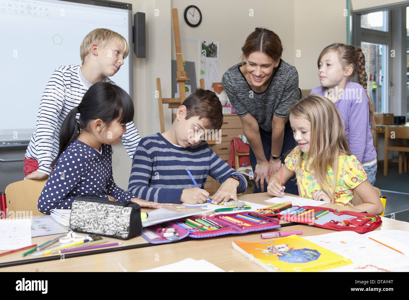 Teacher standing students blackboard hi-res stock photography and ...