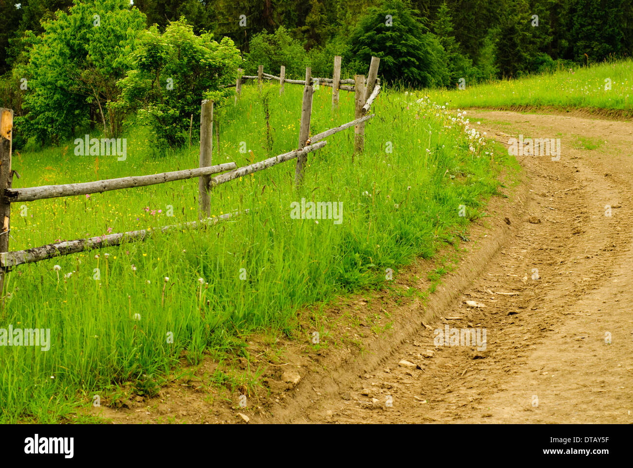 Rural landscape with road and wooden fence Stock Photo - Alamy