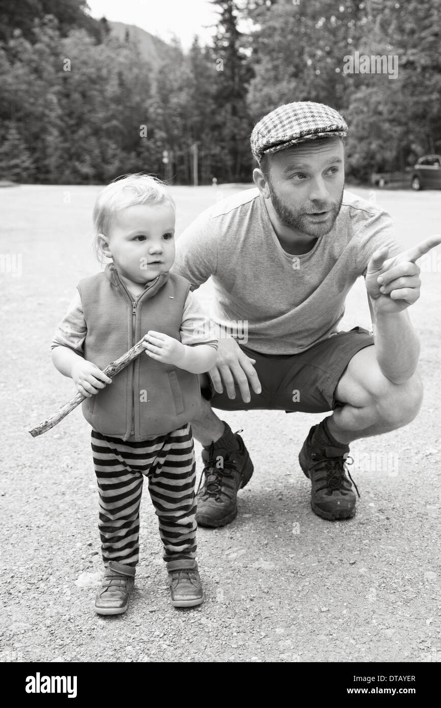 Baby boy with father looking away Stock Photo - Alamy