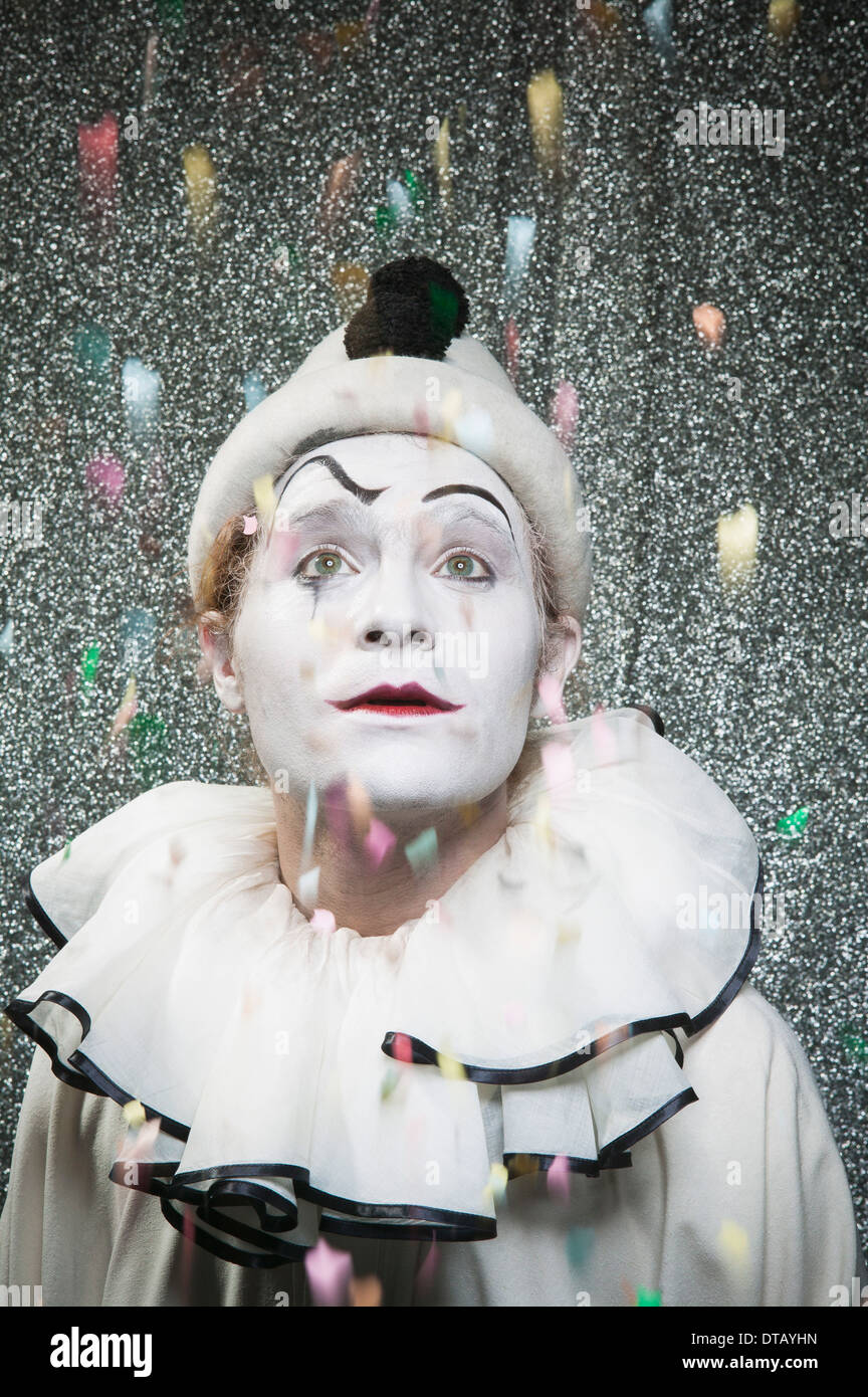 A clown watching confetti fall on stage Stock Photo - Alamy