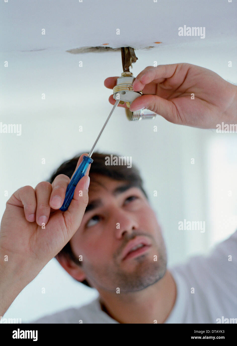 A man fixing a light Stock Photo - Alamy