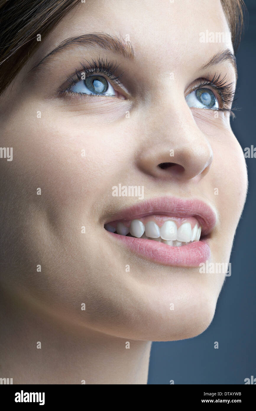 Young woman looking up and smiling, close-up Stock Photo - Alamy