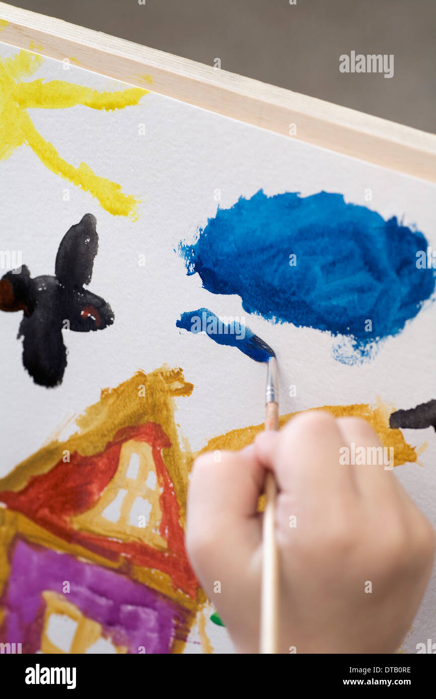 Human Hand painting on easel close-up Stock Photo - Alamy