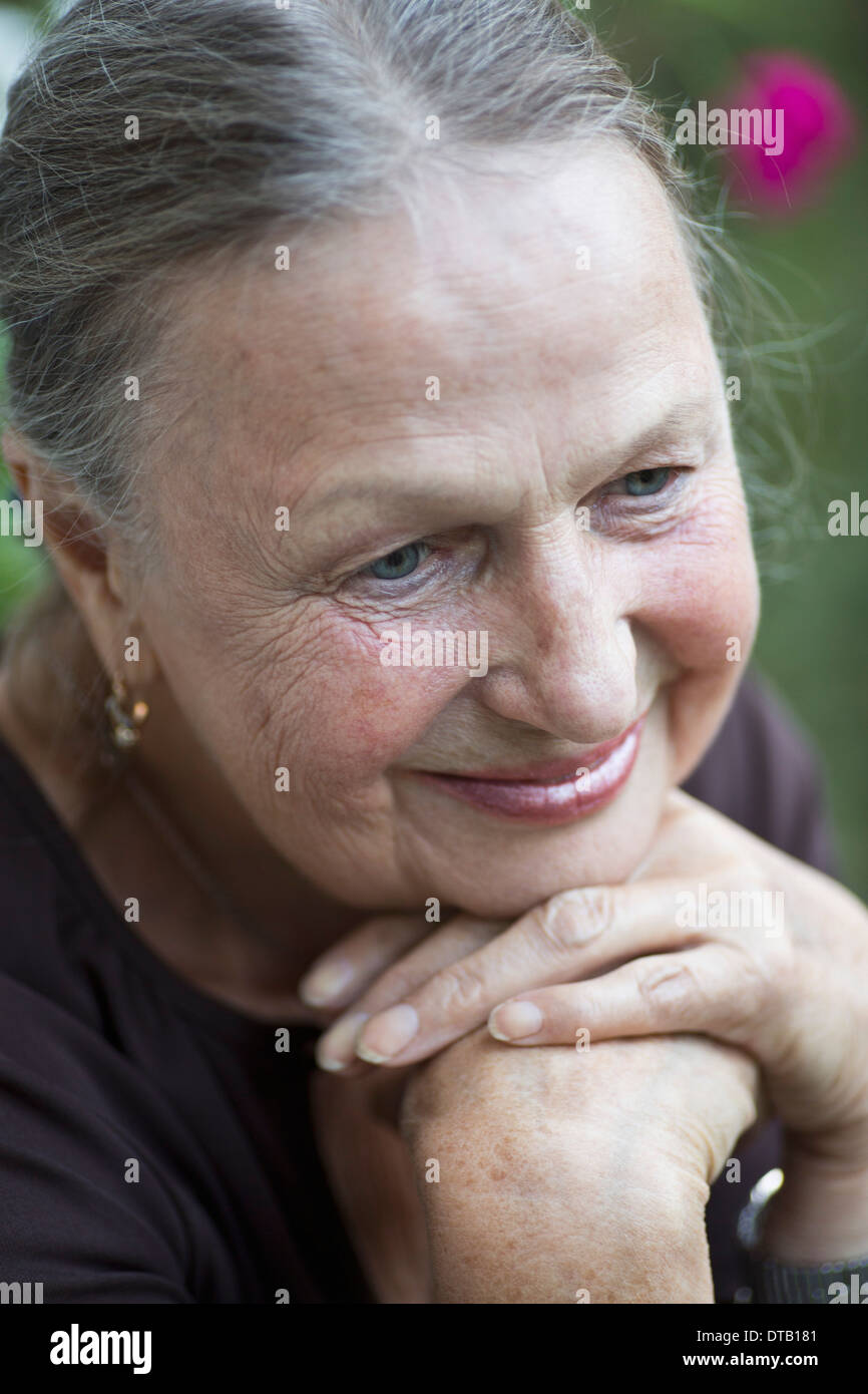 Senior woman looking down, close-up Stock Photo - Alamy