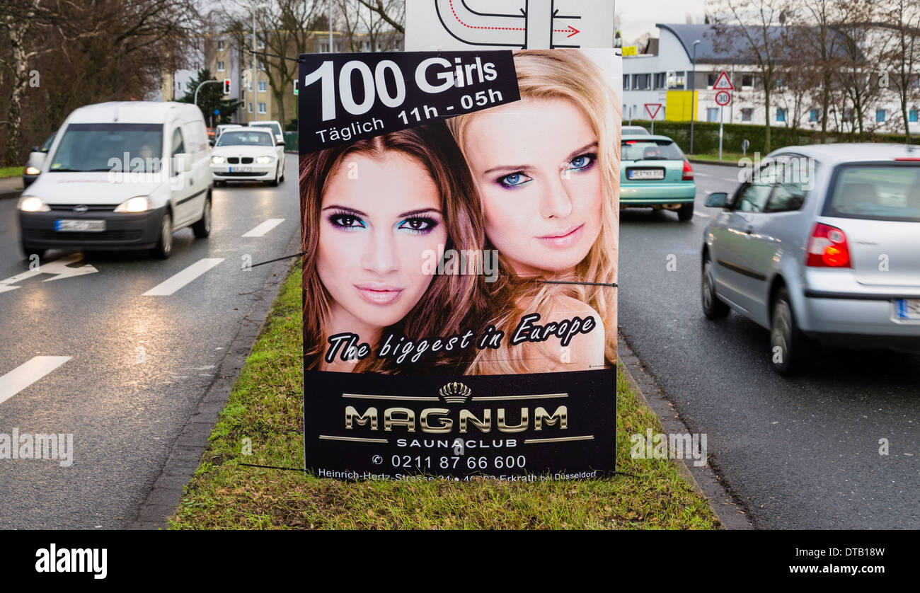 A promotional sign for a house of prostitution stands at the roadside ...