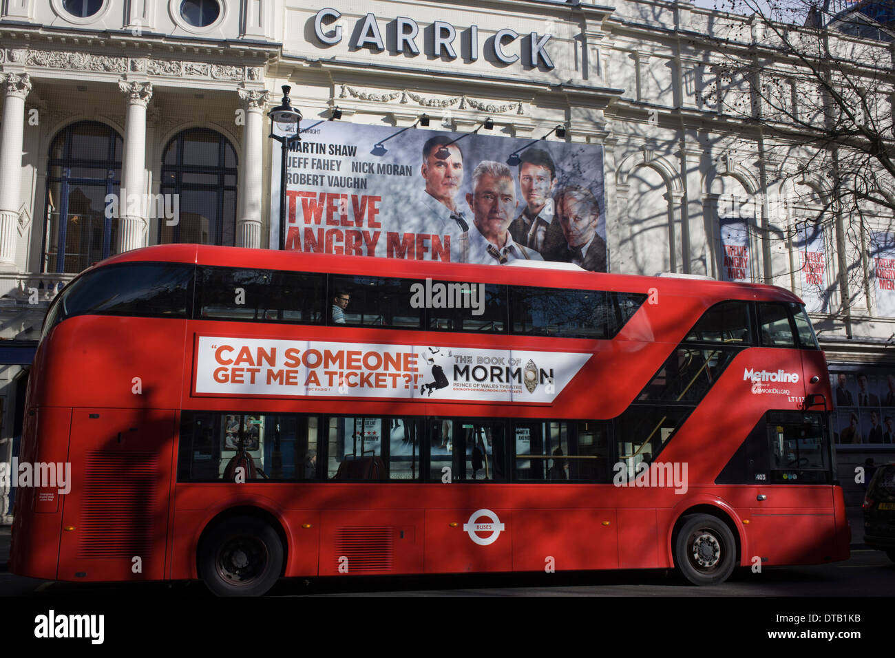Red London Routemaster bus passes Garrick theatre showing a West End ...