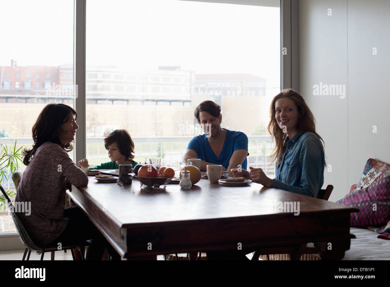 Family having breakfast at dining table Stock Photo - Alamy