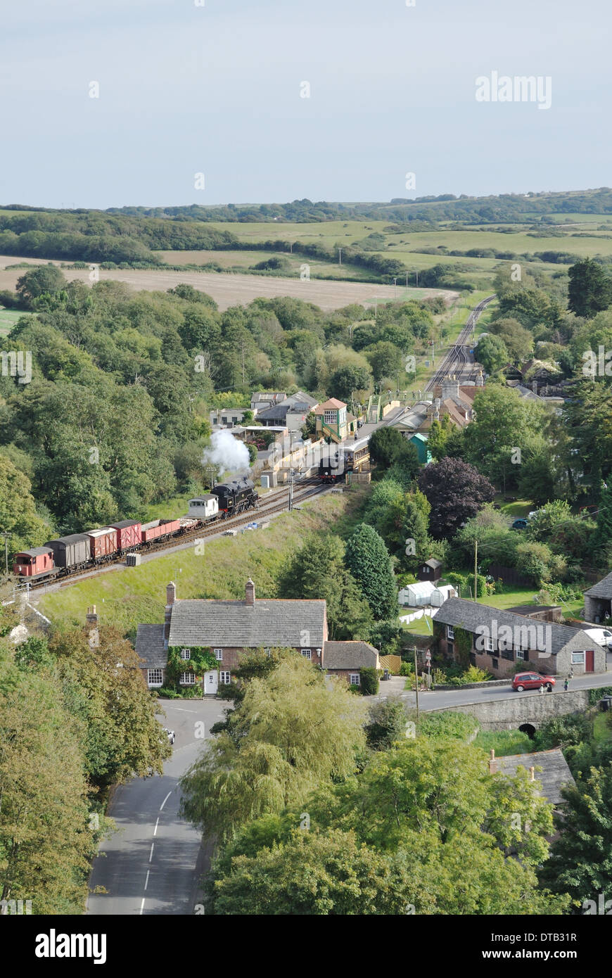 A short goods train approaches Corfe Castle station, on the preserved ...