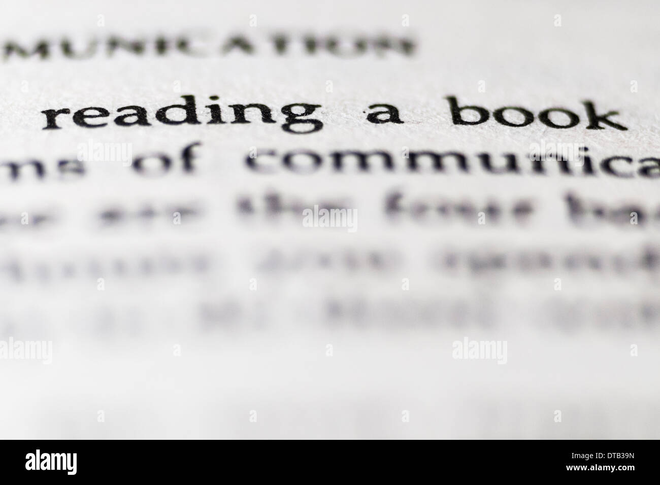 Closeup of text saying 'reading a book' in a paperback book Stock Photo ...