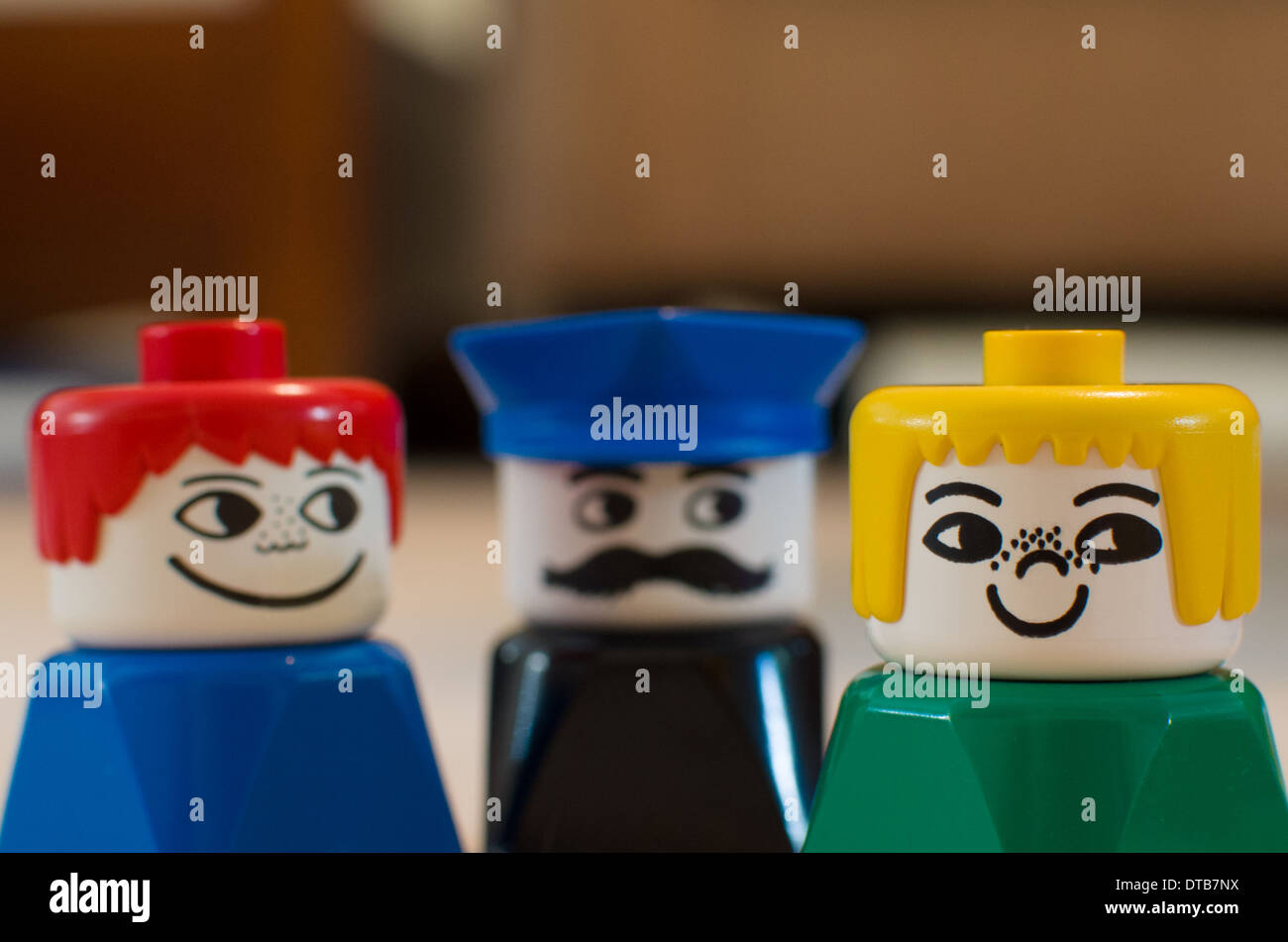 Lego men look at a Lego woman Stock Photo - Alamy