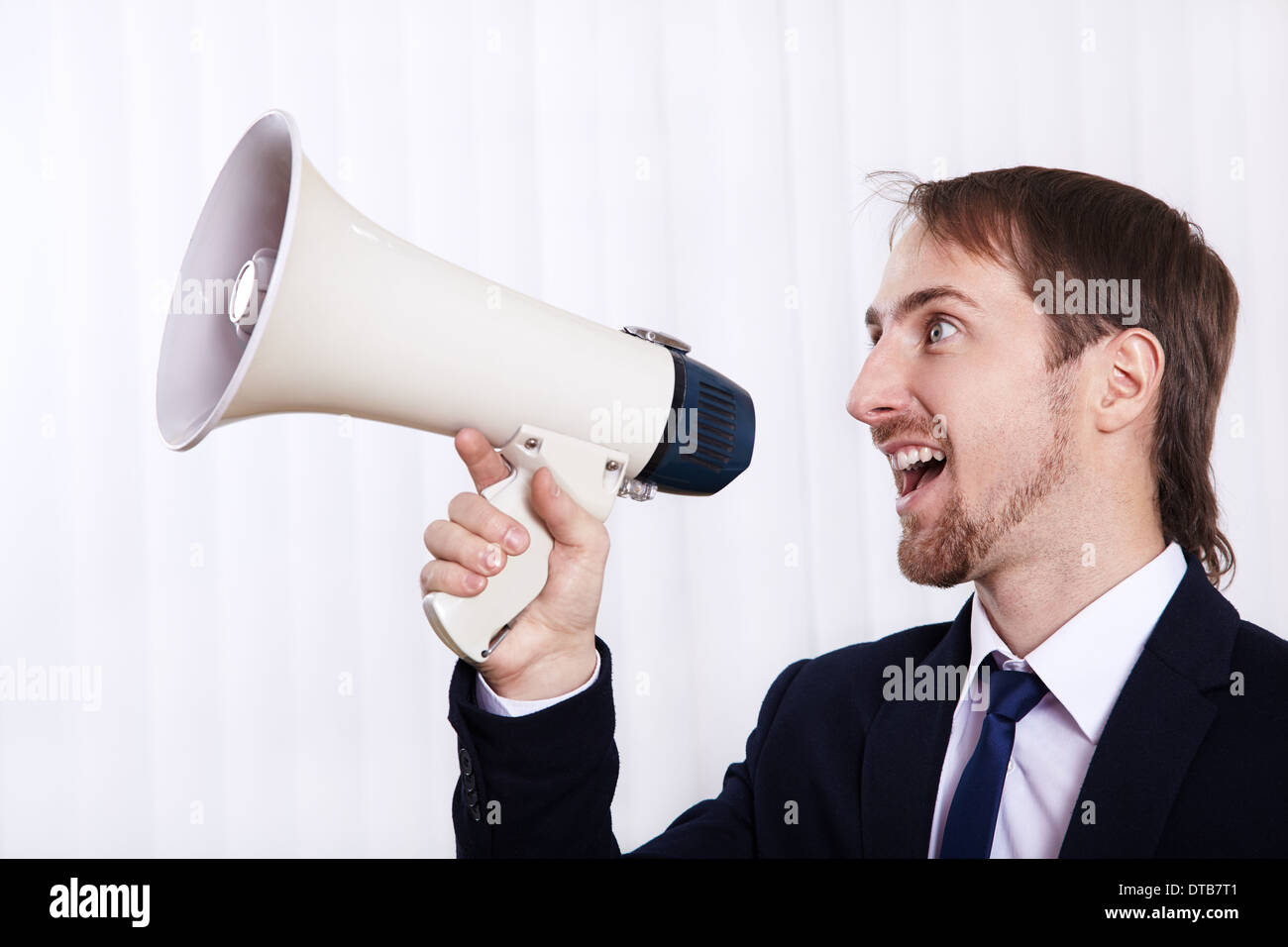 young business man screaming into a megaphone in the office Stock Photo ...