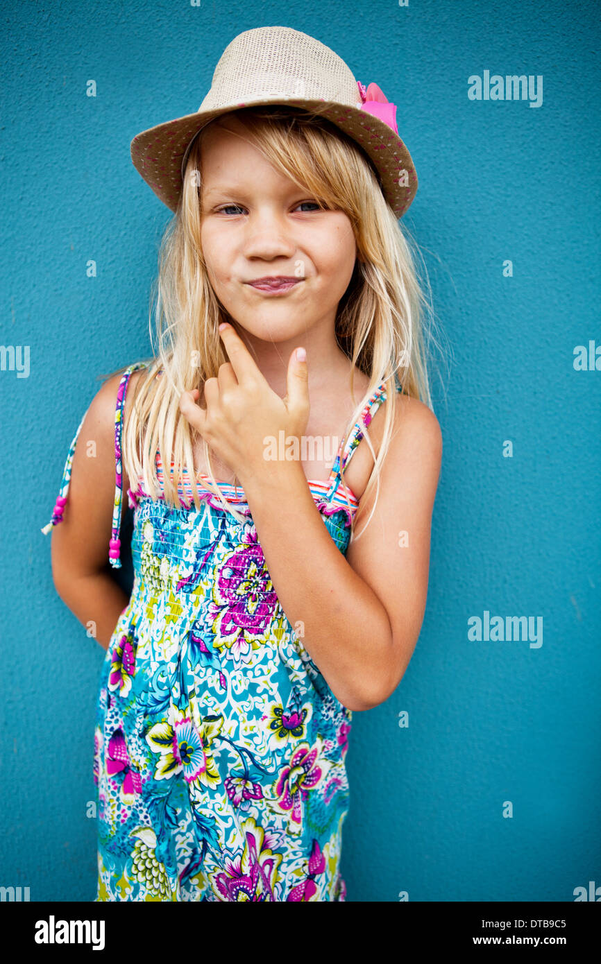 Portrait of stylish cute young girl with smirk expression outside ...