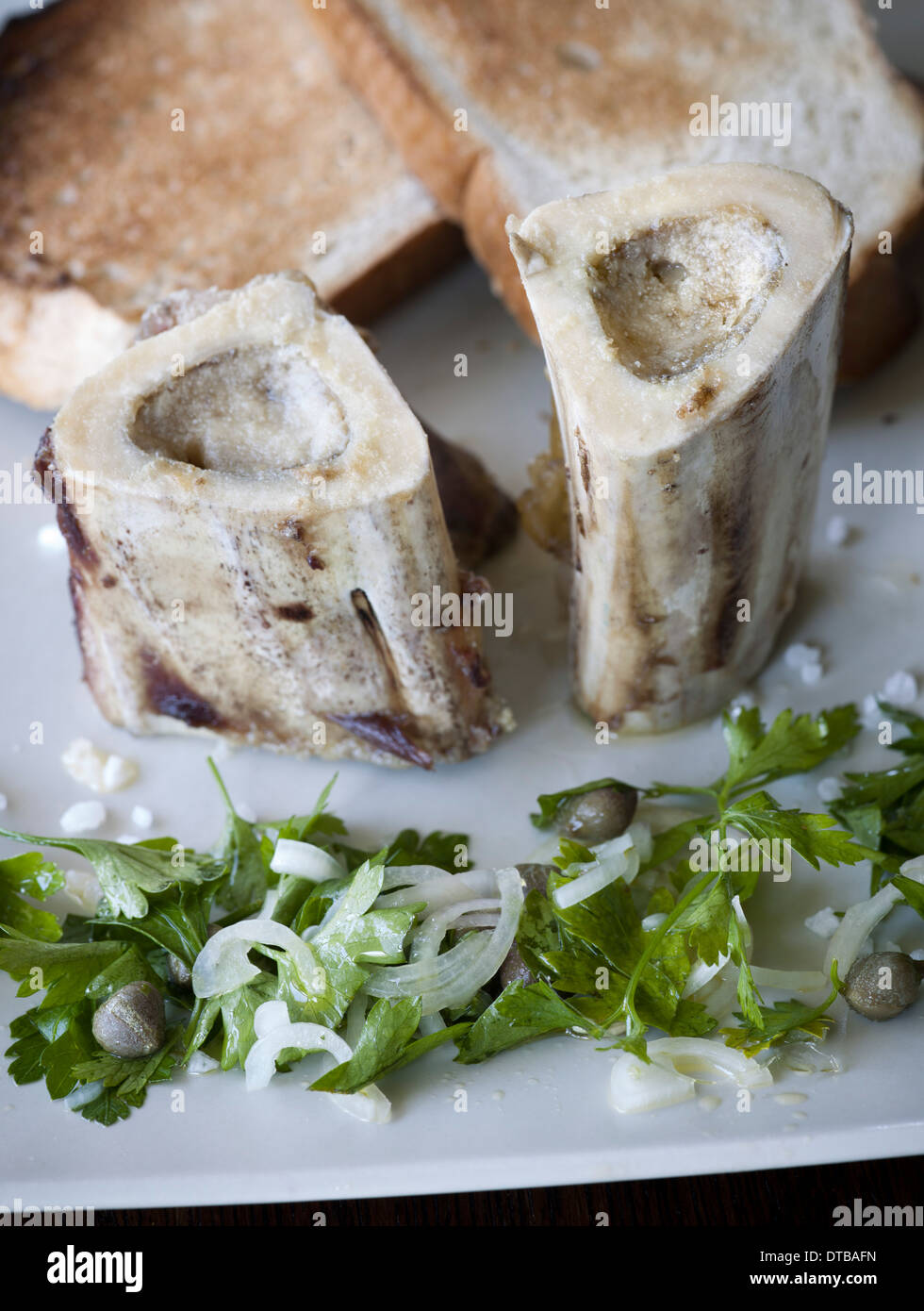 Roast Bone Marrow served with toast and parsley onion and capers - an ...