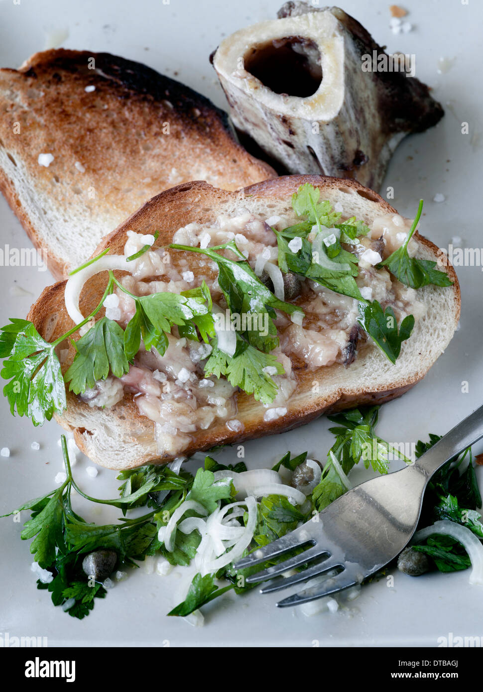 Roast Bone Marrow served with toast and parsley onion and capers - an ...