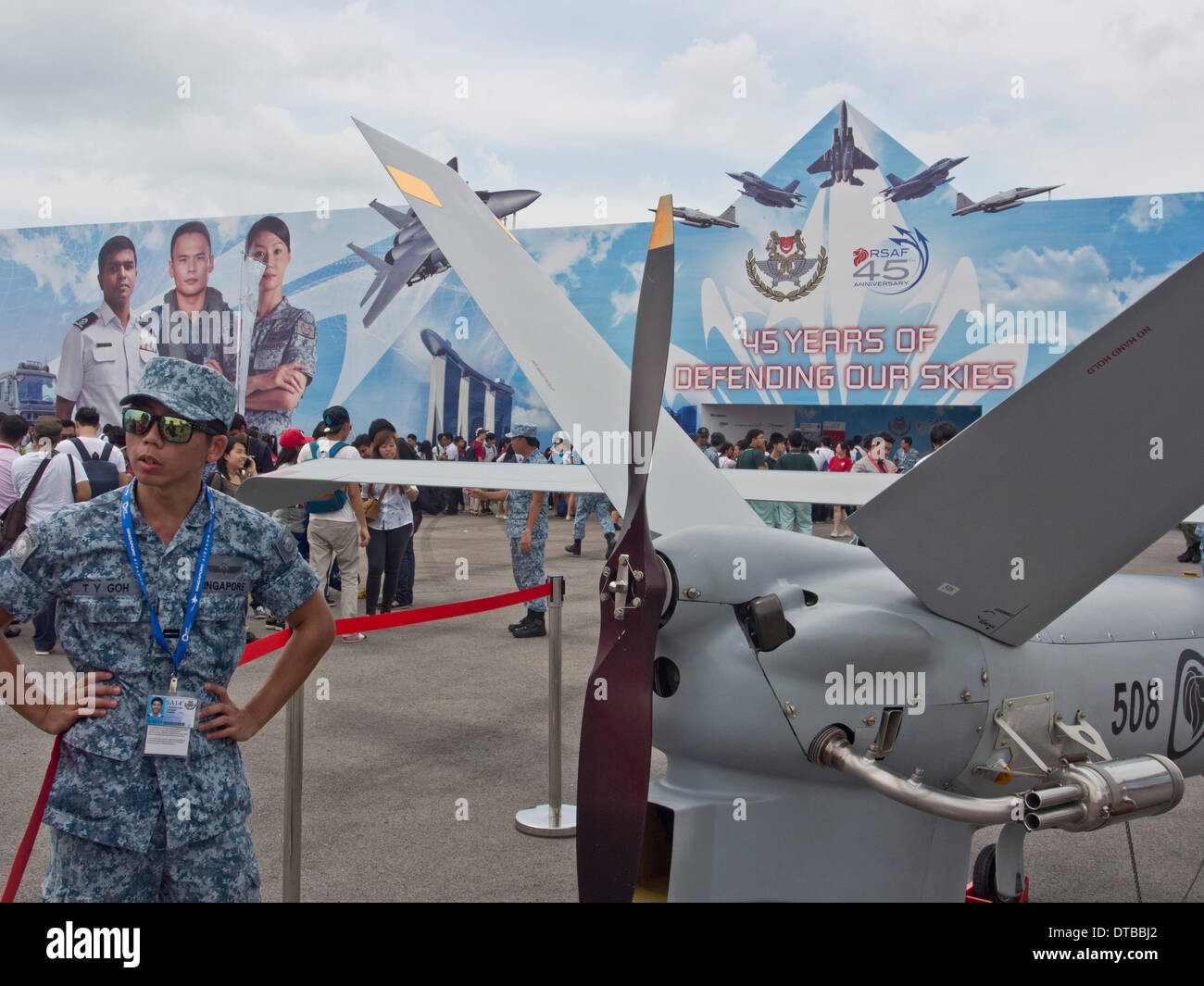 Air Force pilot standing by model of drone at Singapore Air Show Stock ...