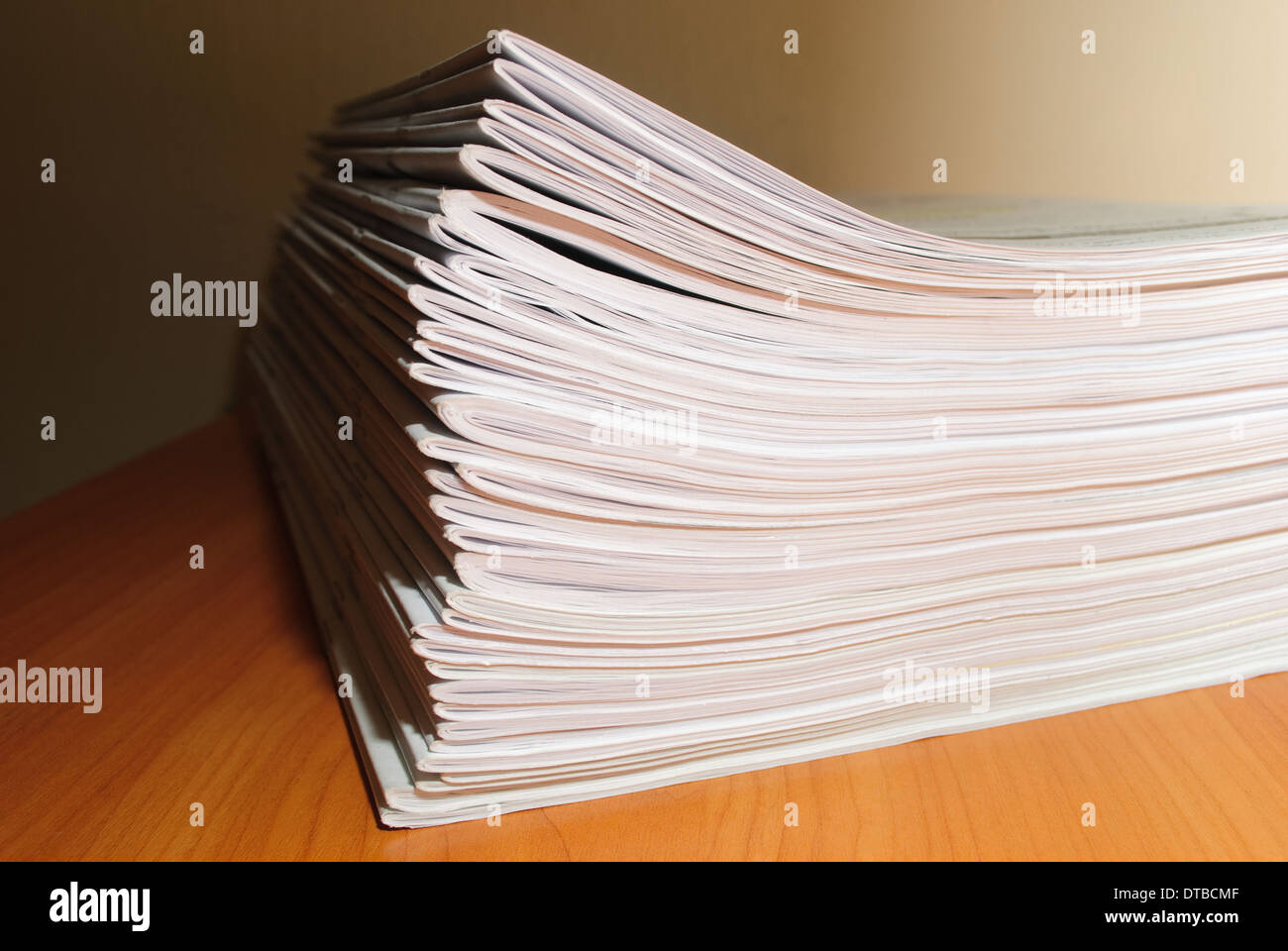 Stack of white journals in office desktop. Shallow deep of field ...