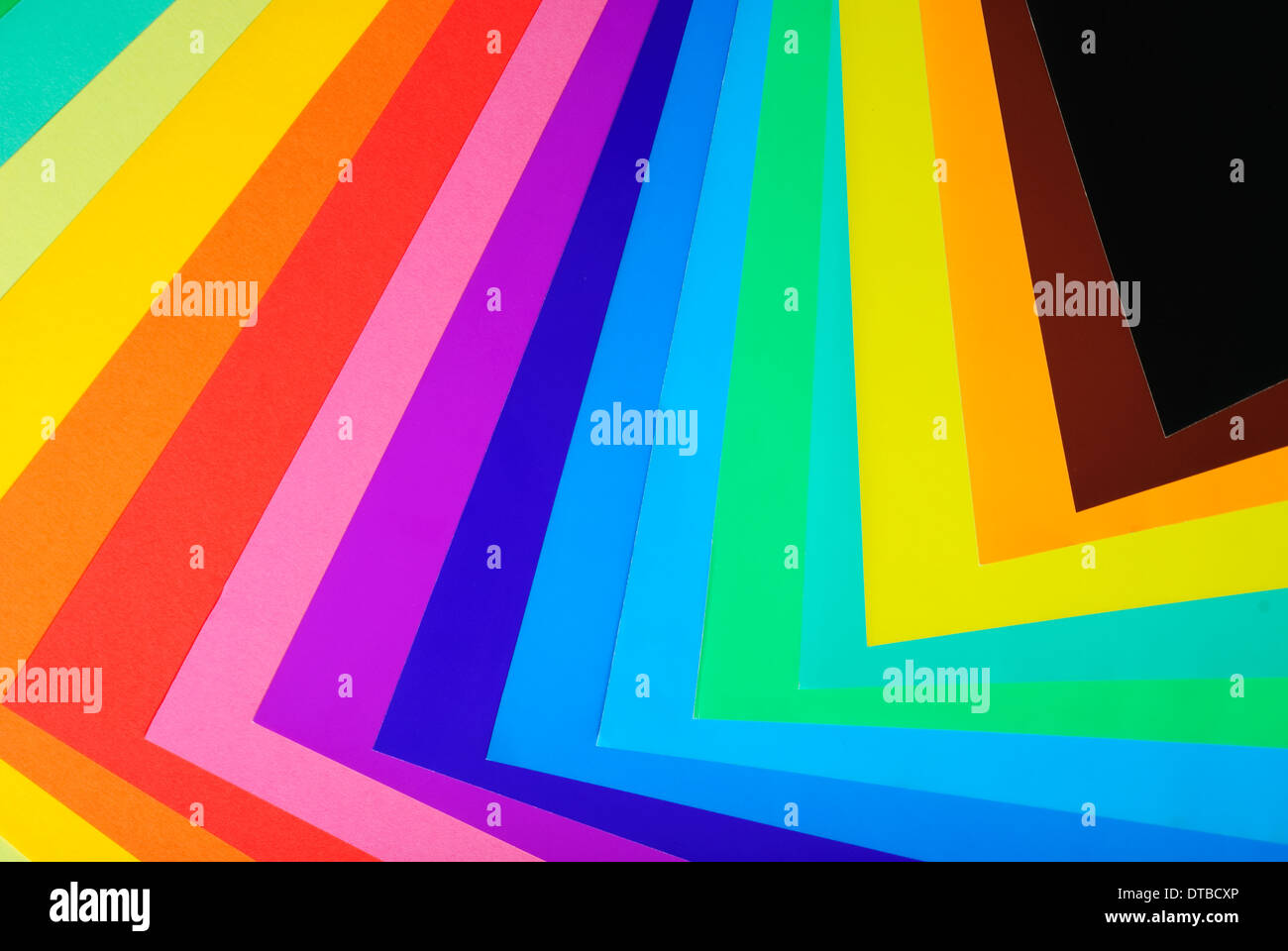 various color paper stack like a rainbow on table Stock Photo - Alamy