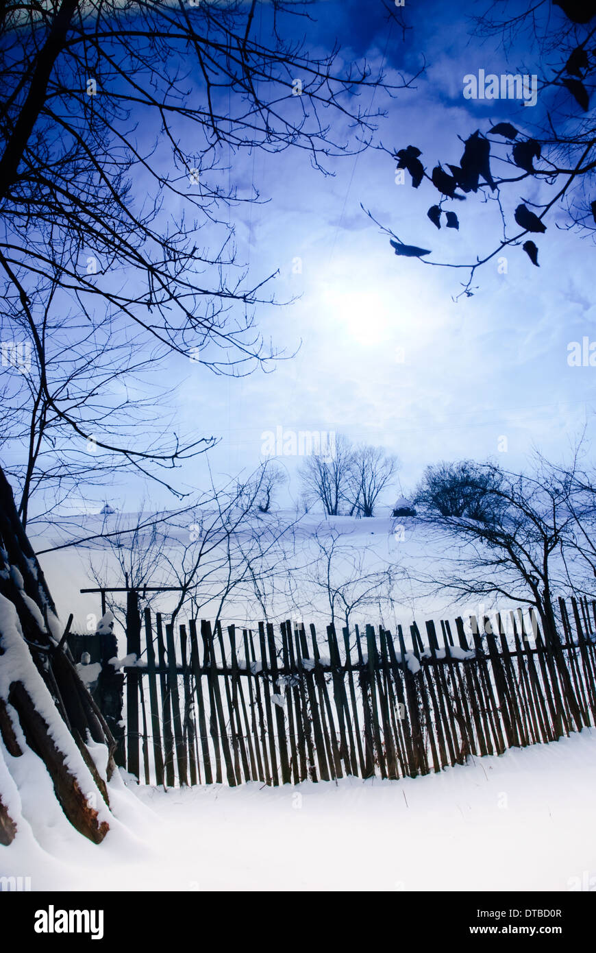 Rural winter mountain landscape with sundown and road, trees, fence ...