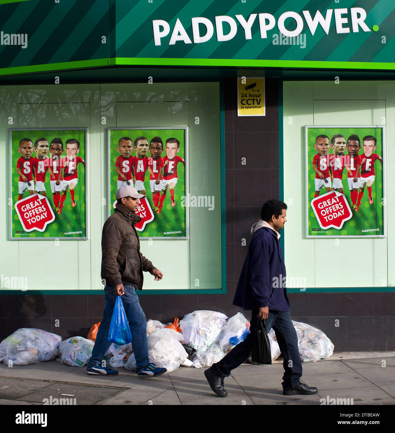 People walk past a branch of Paddy Power bookmakers in Hackney, London ...
