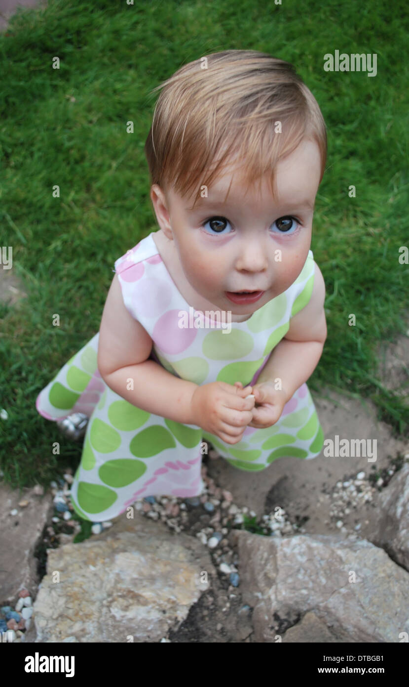 Little girl look upwards with interest Stock Photo - Alamy