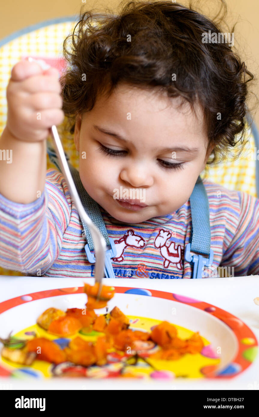 Baby eating alone hi-res stock photography and images - Alamy